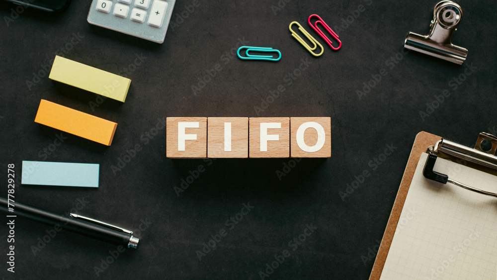 There is wood cube with the word FIFO. It is as an eye-catching image ...