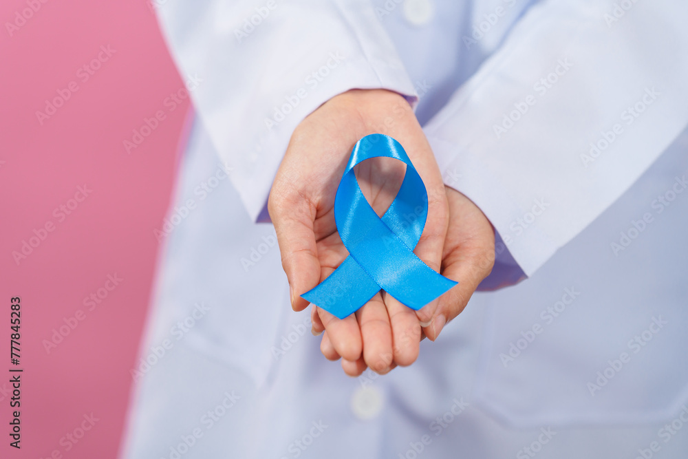Prostate cancer awareness. Close up medical doctor holding ribbon over ...