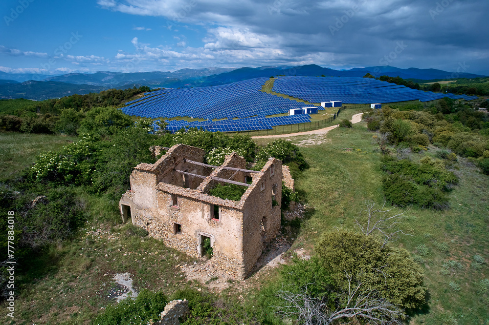 Renewable energy transition - house roof ruin and solar farm Stock ...