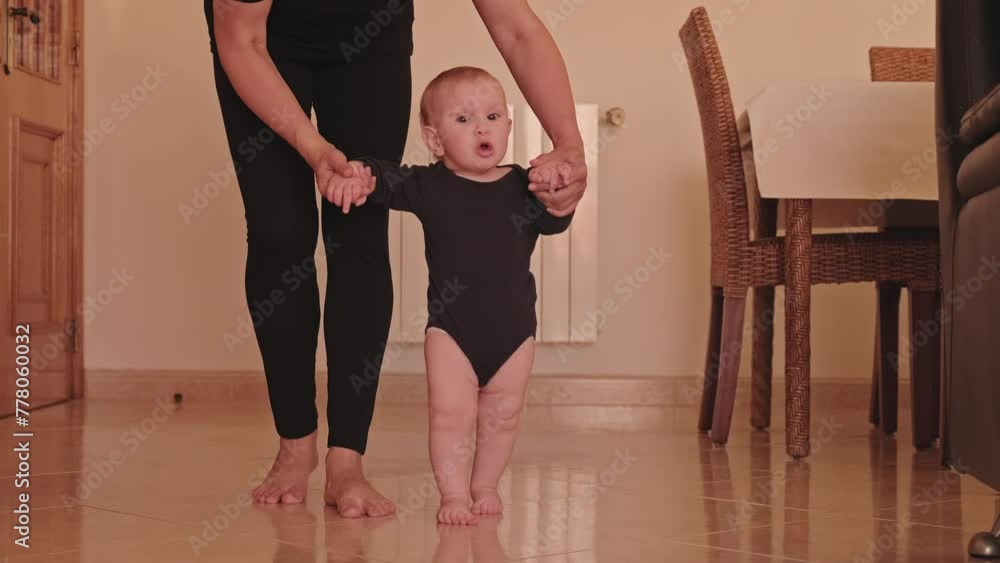 Cute baby trying to walk for the first time. Adorable infant holding ...