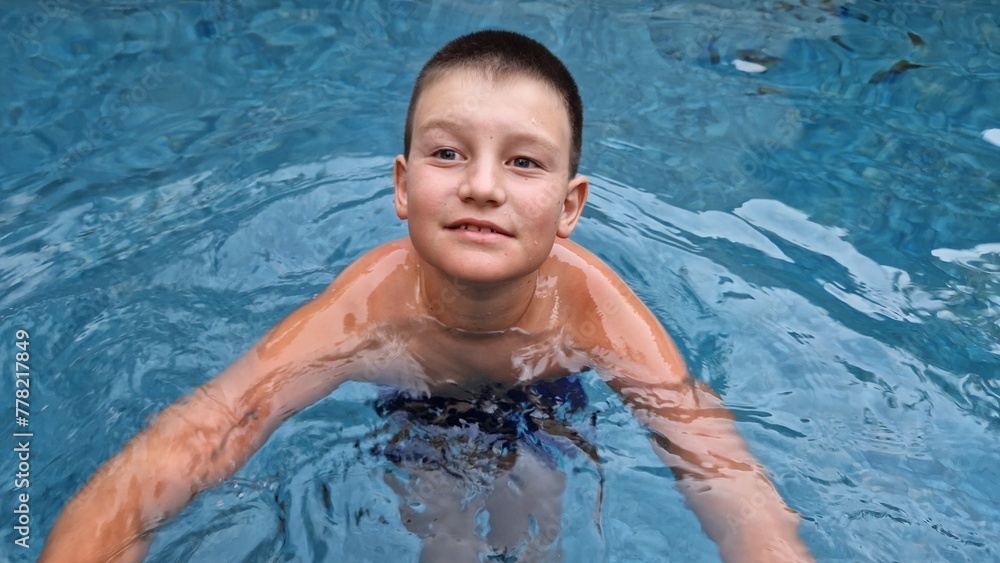 Child having blast on vacation in pool Shimmering water of the pool ...