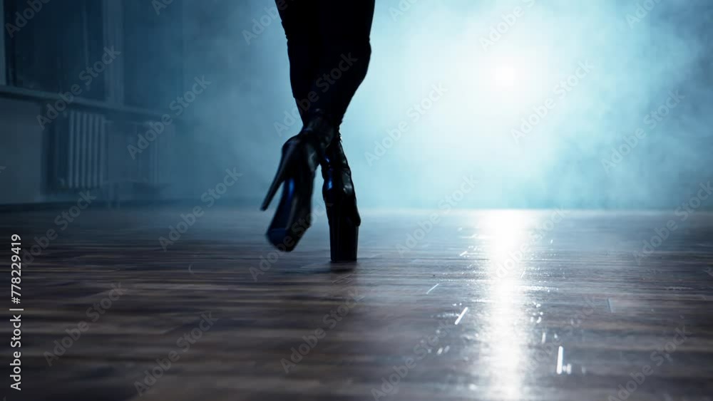 Elegant female heels dancer at smoky stage with spotlights. Close up of ...
