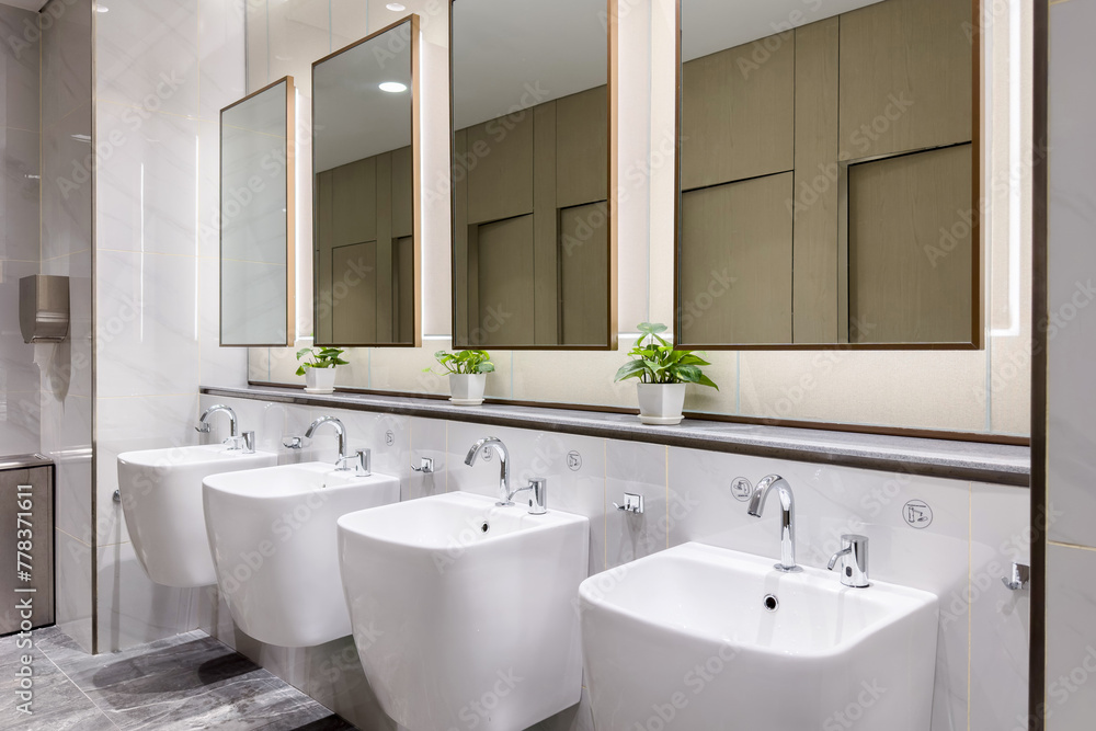 Toilet hand wash area with white colour ceramic tiles. White colour ...