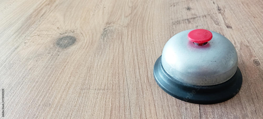 Reception or service bell with a shiny metal surface and a black ...