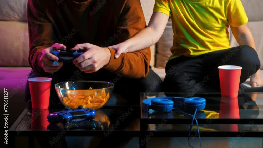 Younger brother sits down on the sofa with his older brother and asks ...