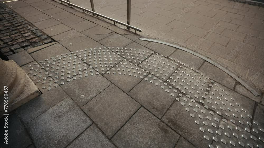 Metropolitan navigation: Elevated view of tactile pavement with braille ...