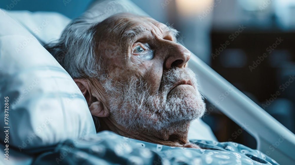 A weary old man lies in a hospital bed, surrounded by medical equipment ...