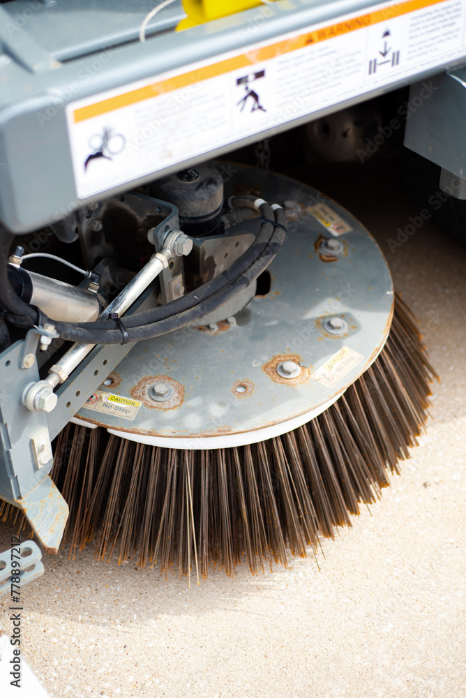 Close-up side gutter broom on modern single-engine mechanical sweeper ...