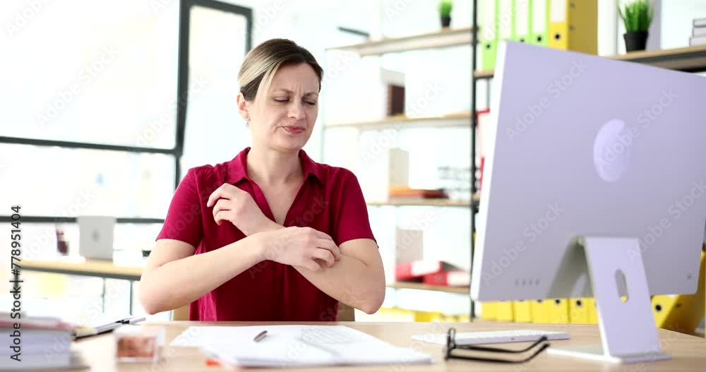 A business woman sitting in the office itches, slowmotion. Nervous ...