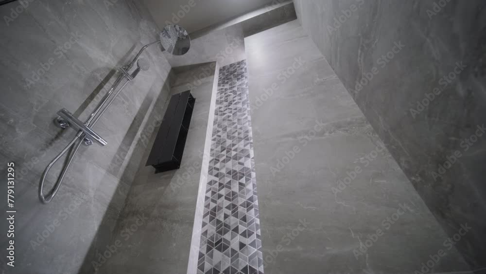 Modern bathroom with wide walk-in shower, featuring a rain showerhead ...