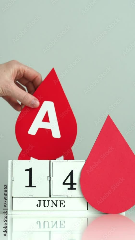 A woman's hand puts a drop in the donation slot. Concept of blood donor ...