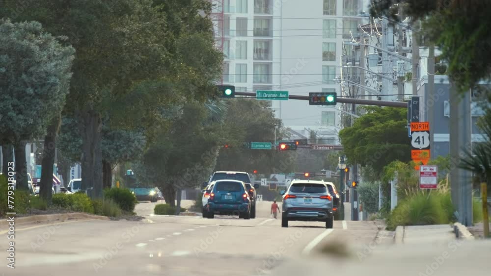 Cars traffic driving at intersection on American street with traffic ...