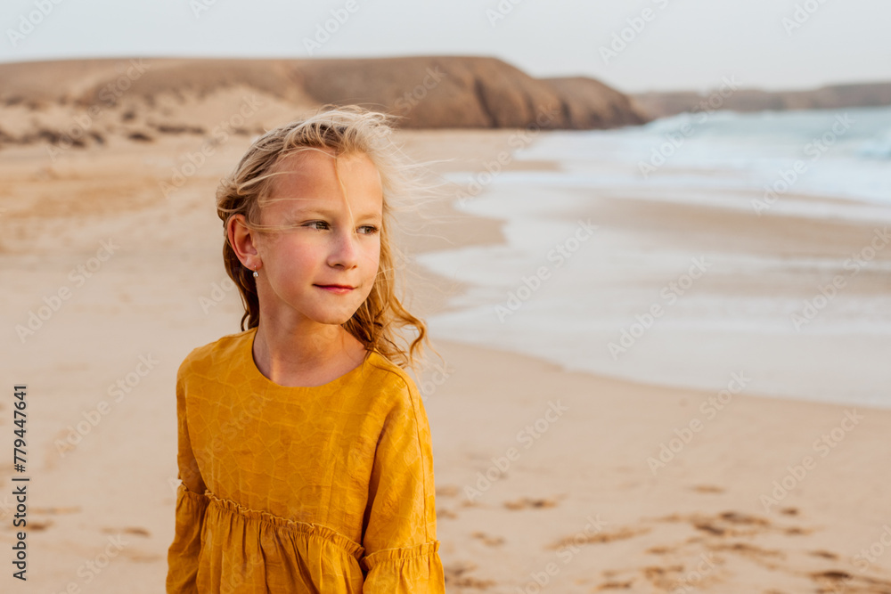 Young girl on beach. Smilling blonde girl enjoying sandy beach, looking ...