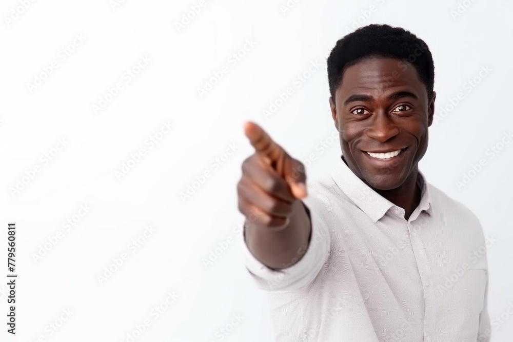 A black man with a smile on his face points his index finger at an ...