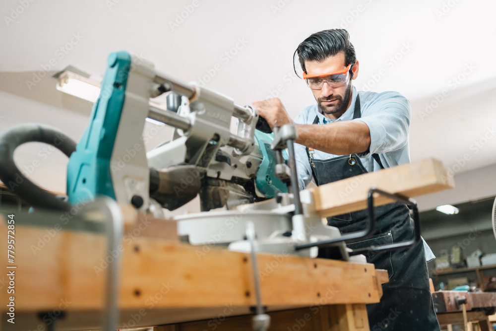 Diligently skilled man work with wood in carpenter's shop, using tools ...