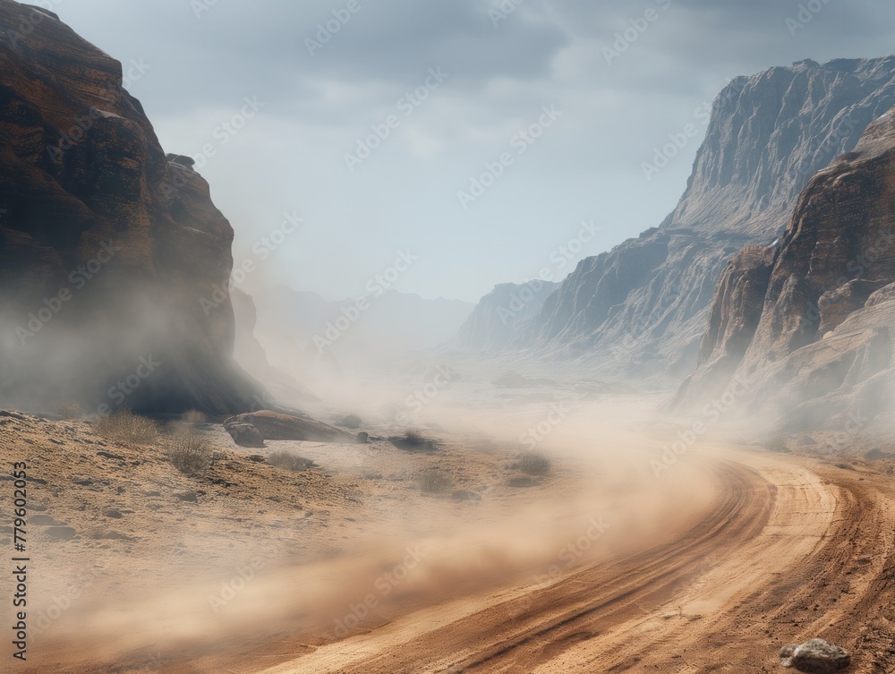 A dusty road winds through a desert landscape. The sky is overcast, and ...
