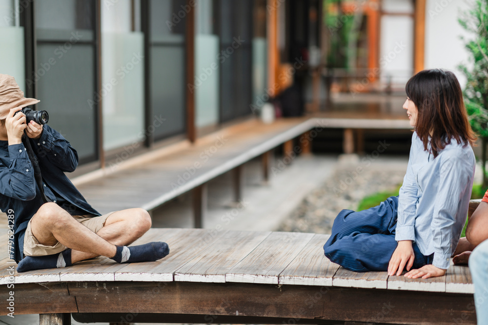 An enthusiastic Japanese photographer focuses intently on his subject ...