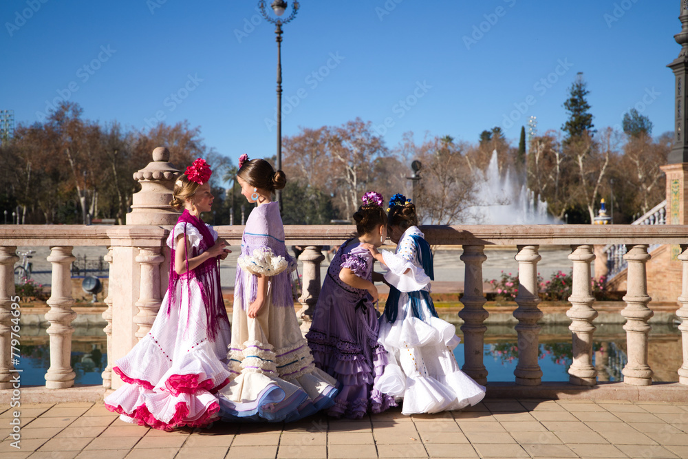 four pretty little girls dancing flamenco dressed in typical gypsy ...