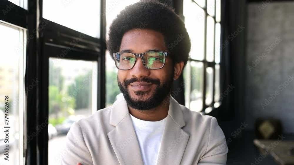 Brazilian businessman in glasses and afro hairstyle looks aside ...