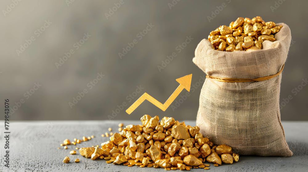 Overturned sack of gold nuggets on grey table and arrow up showing gold ...