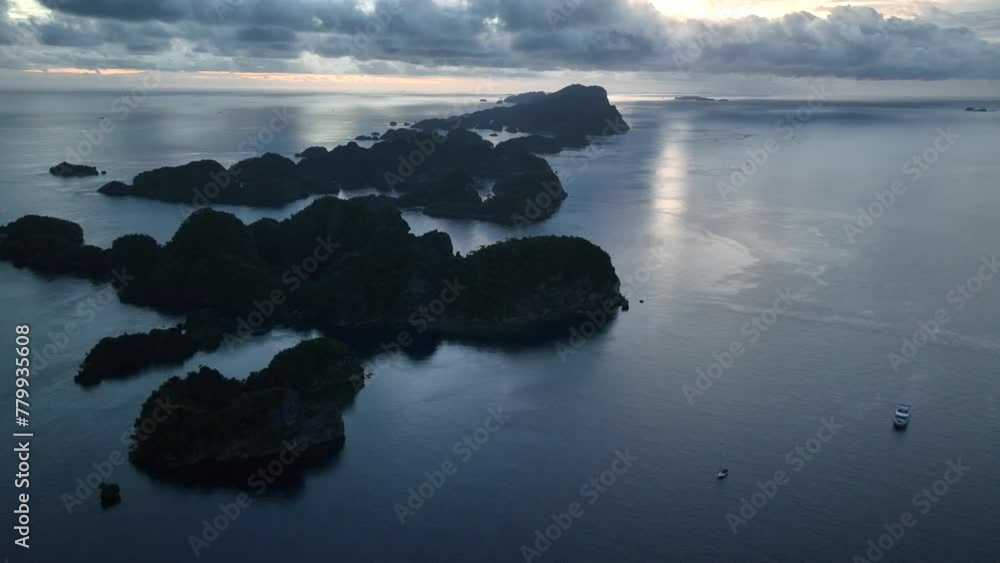 Dawn illuminates scenic islands scattered amid Raja Ampat's tropical ...