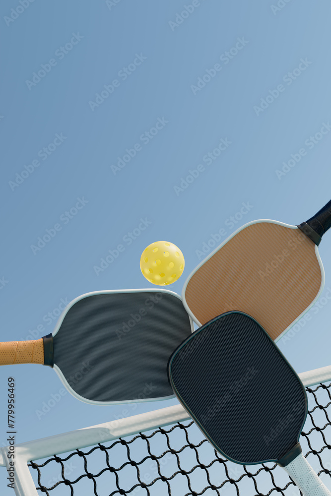 Three crossed pickleball rackets with a ball over a sports net against ...