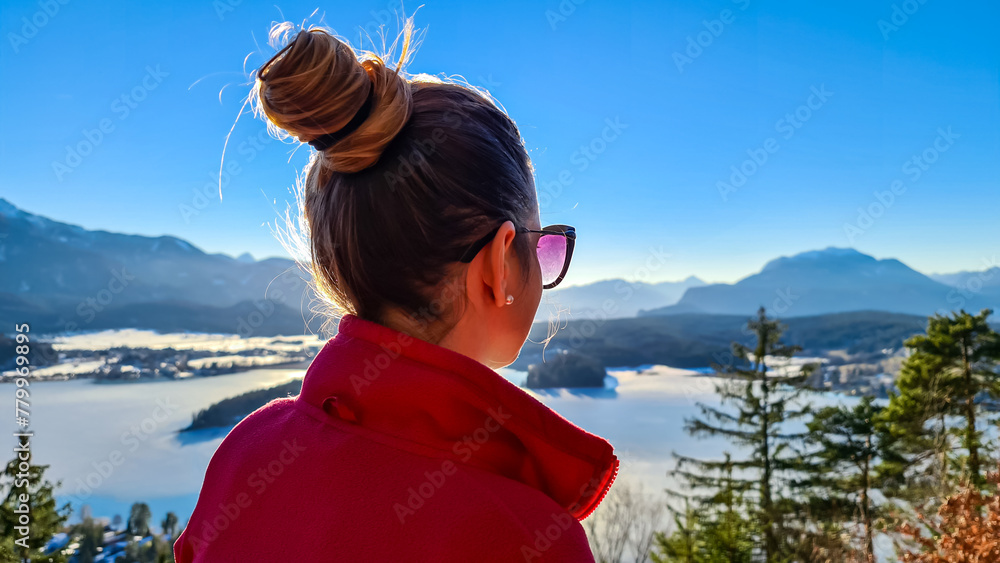 Woman sitting on railing of Taborhoehe viewing platform in Carinthia ...