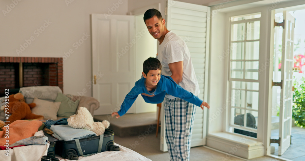 Father playing airplane with his child in the living room for bonding ...