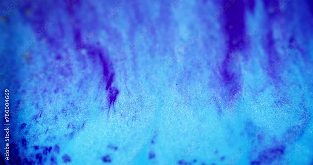 Wet glitter flow. Ink spill. Sparkling fluid. Defocused blue purple ...