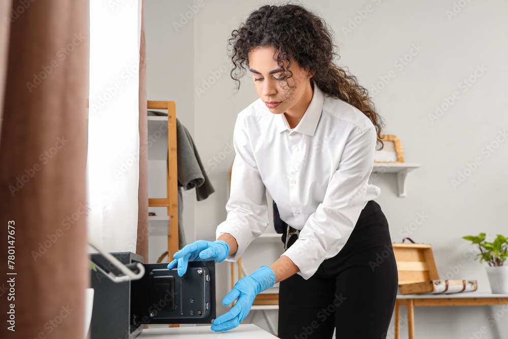 African-American police officer working at crime scene indoors Stock ...