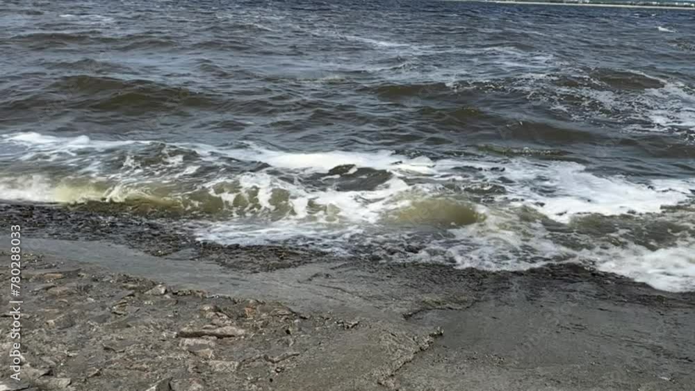 Horizontal video of water of Volga River beating against concrete slabs ...