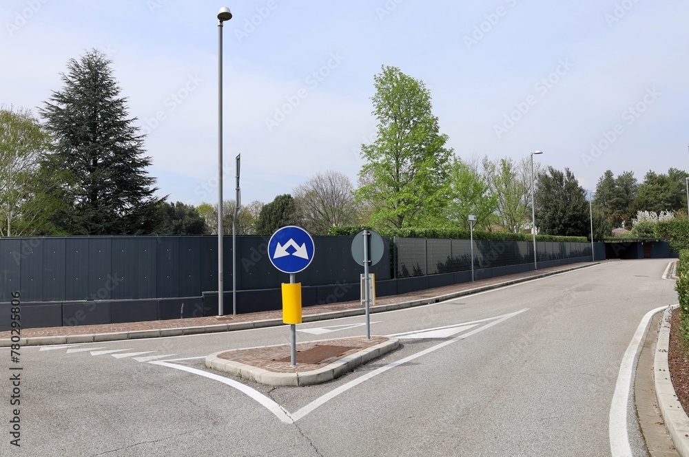 Double arrow traffic sign, or split road sign, at the end of a ...