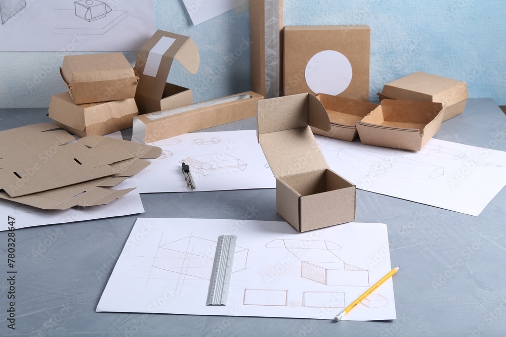 Creating packaging design. Drawings, boxes and stationery on blue ...