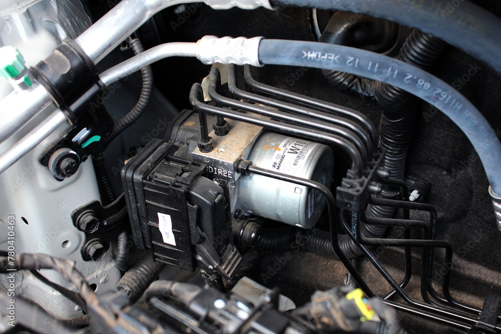 Vinnytsia, Ukraine; April 05, 2024. Close up Kia Sportage ABS motor control module in the car ...