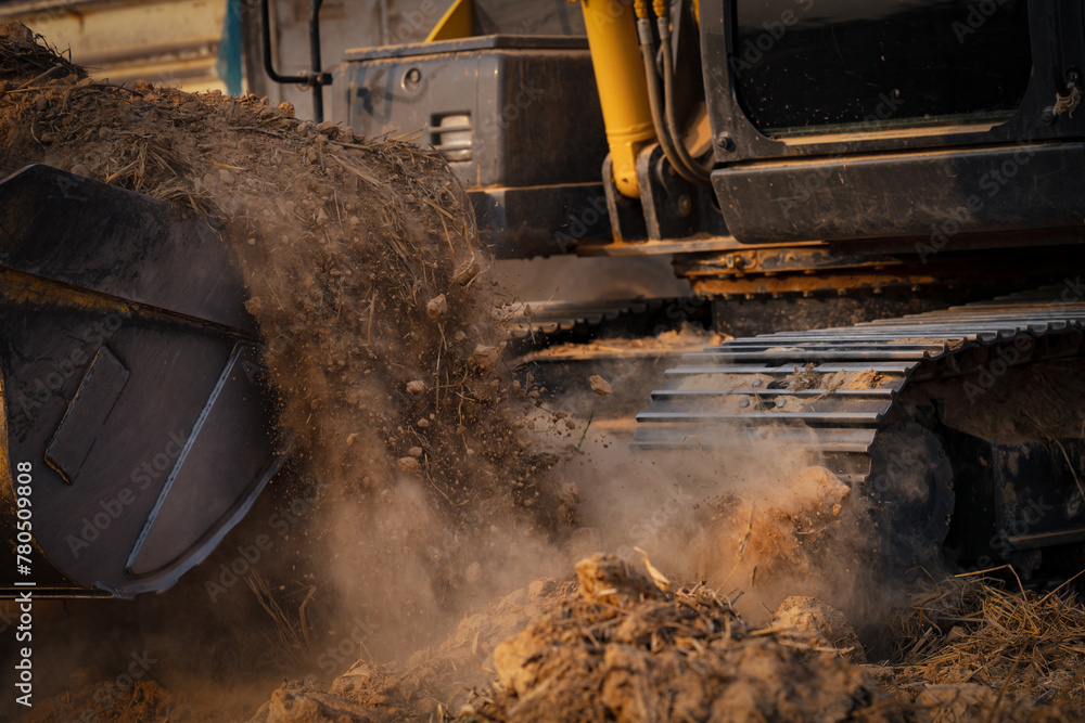 Selective focus on metal bucket teeth of backhoe digging soil. Backhoe ...