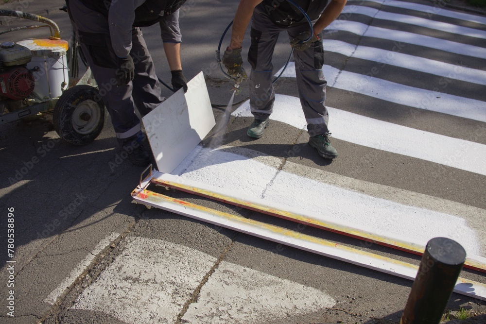 Workers are updating the pedestrian crossing markings Stock Photo ...