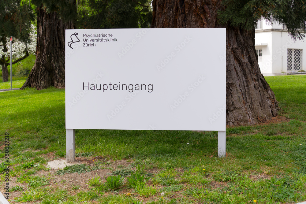Entrance of University Psychiatric Hospital with white sign and tree in ...
