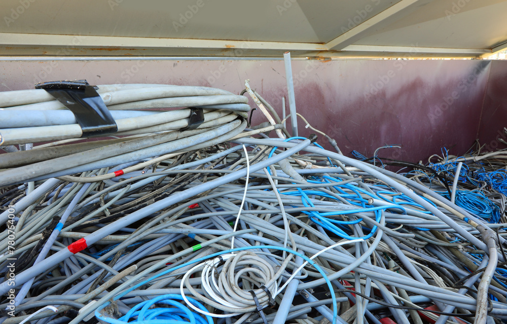 Inside a container with bundles of old copper and PVC electrical cables ...