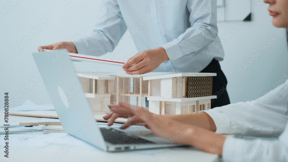 Professional male architect using ruler to measure house model length ...