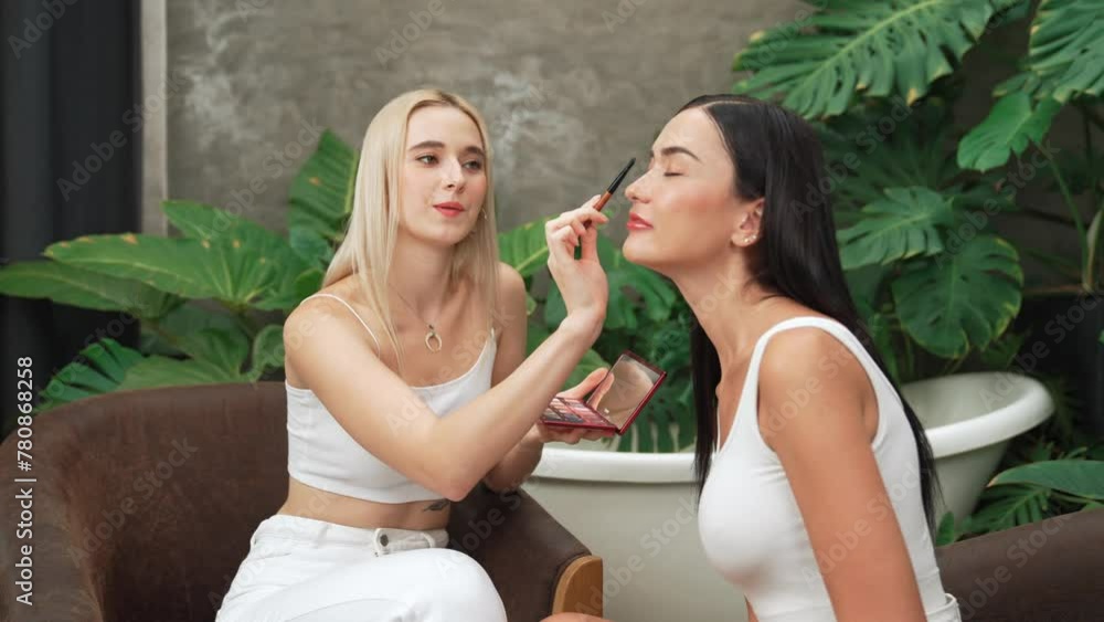 Two beautiful content creator making natural beauty and cosmetic tutorial on green plant leave ...