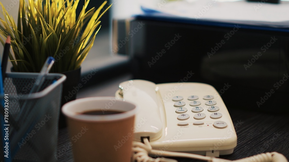 Cup of coffee on office desk next to paperwork containing business ...