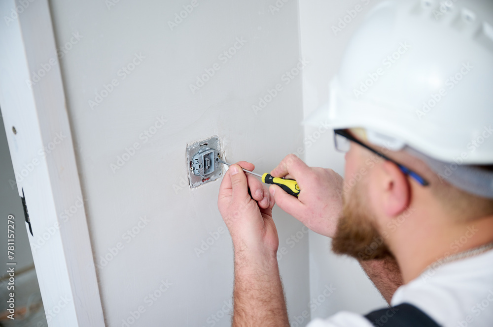 Crop view of electrician installing electric socket using screwdriver ...