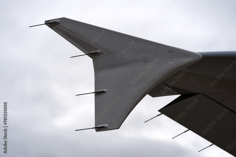 Close-up of aircraft wing tip with gray sky background at Swiss airport ...