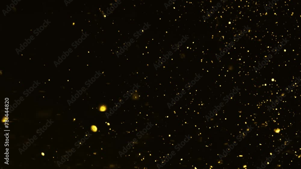 Golden glitter background in slow motion. Beautiful transition with real gold particles flying ...