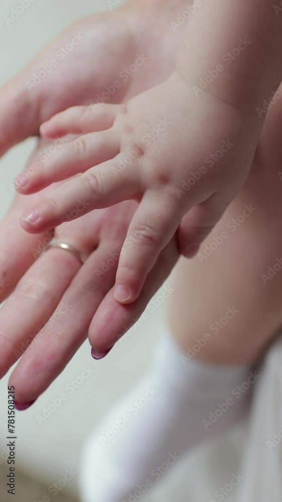 Hand of a newborn. Baby hand in mother hand. Vertical video. Stock ...