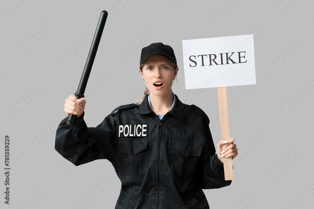 Protesting female police officer holding baton and placard with text ...