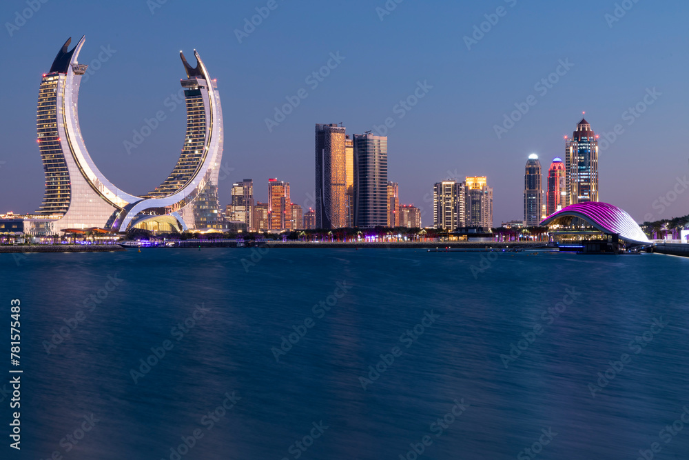 Crescent tower from Al Maha Island in Qatar, with a brightly blue sky ...