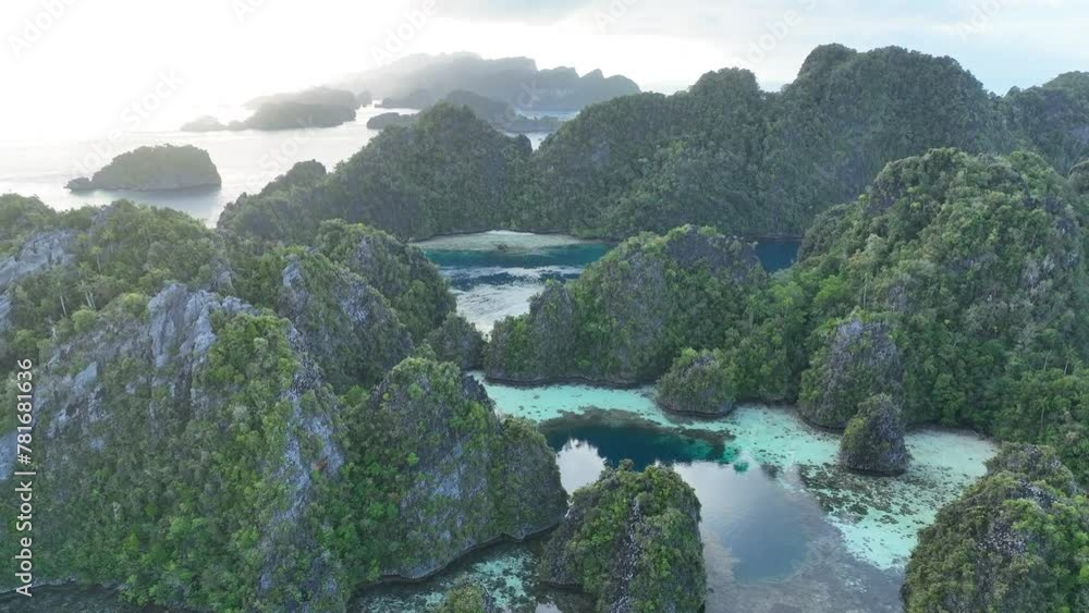 Dawn illuminates scenic islands scattered amid Raja Ampat's tropical ...