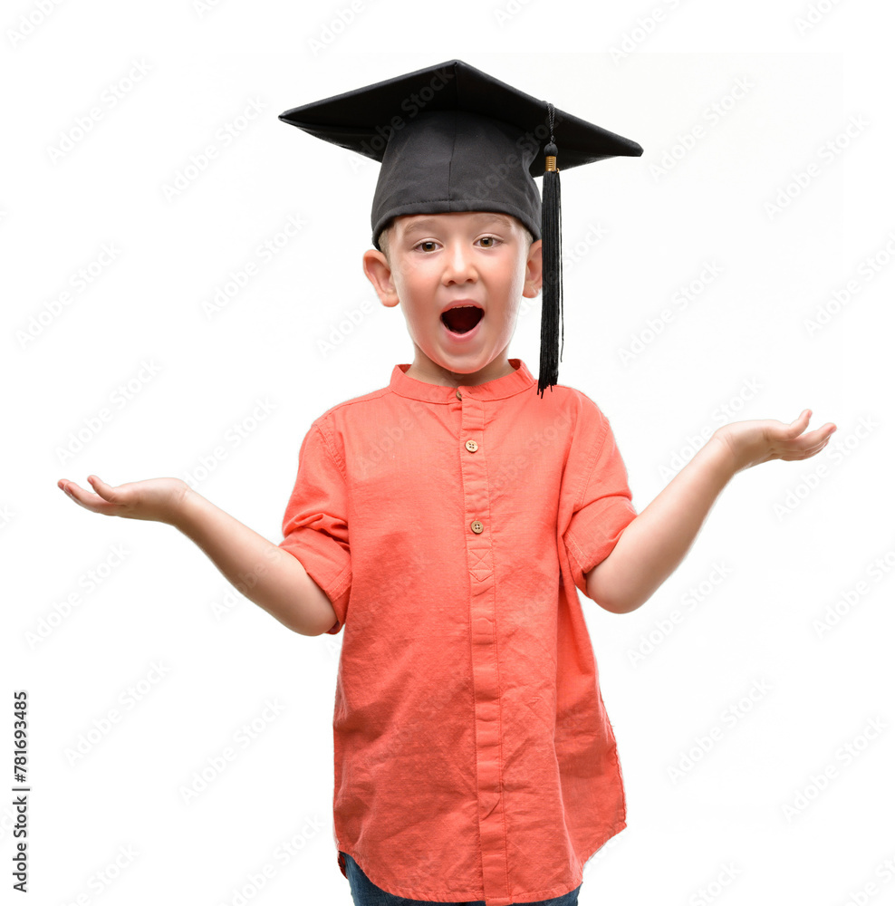 Dark haired little child wearing graduation cap very happy and excited ...
