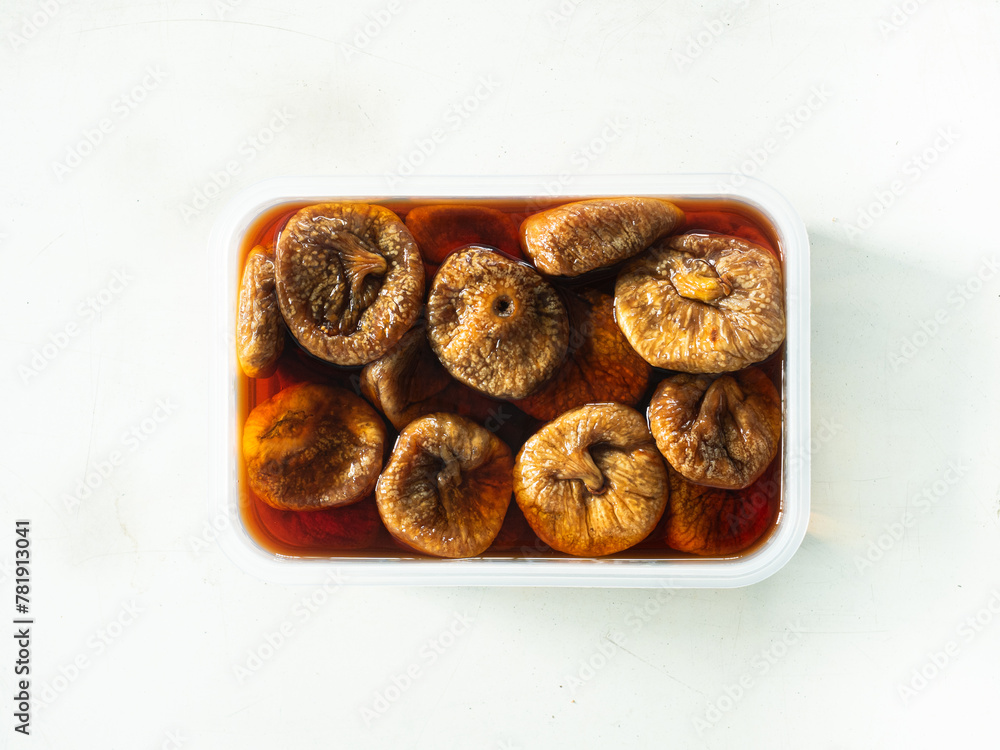 top view dried figs soaked in dark rum in plastic food container Stock ...